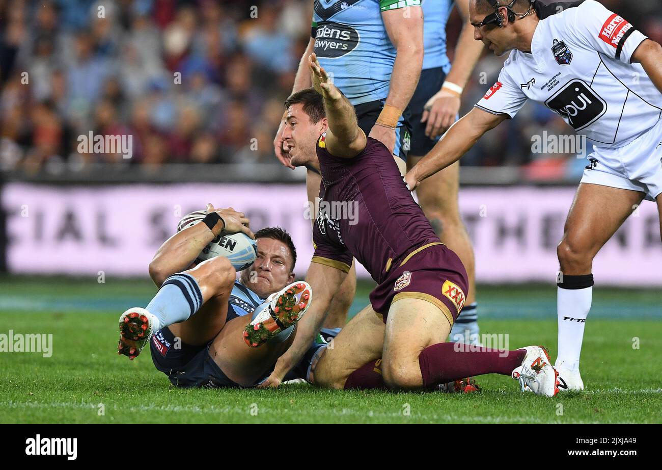 Ben Hunt of the Maroons after tackling Tariq Sims of the Blues (left ...