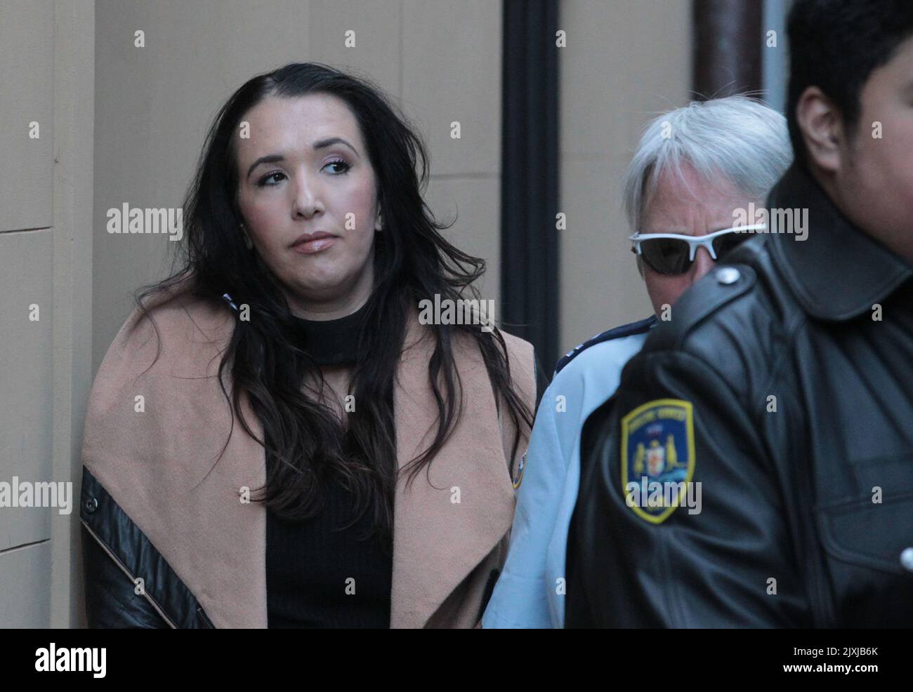 Louise Catherine Spiteri-Ahern (left) is seen being led into prison van ...