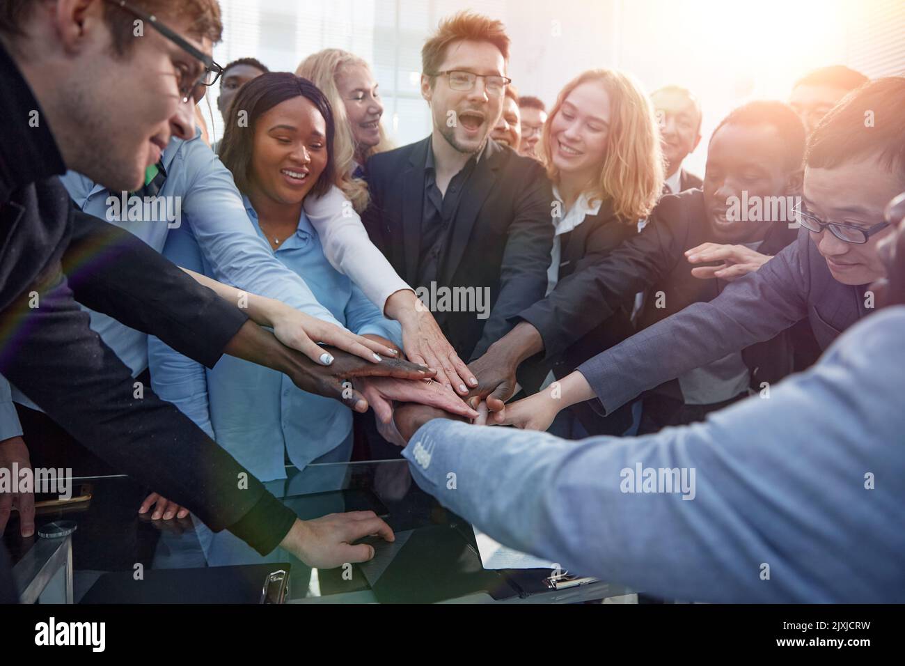 Business team stacking their hands together Stock Photo - Alamy