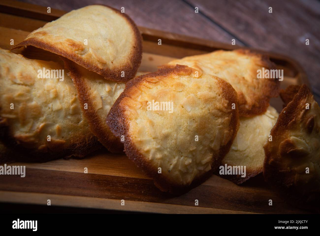 French delicacy pastry tuile with almond on wood background Stock Photo ...