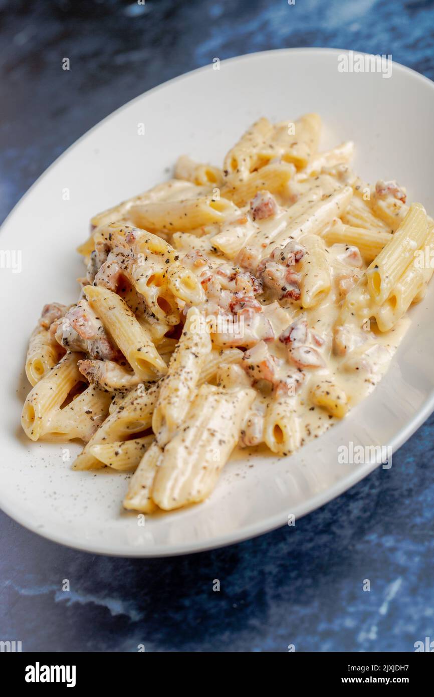 A vertical closeup of pasta served in a restaurant Stock Photo - Alamy