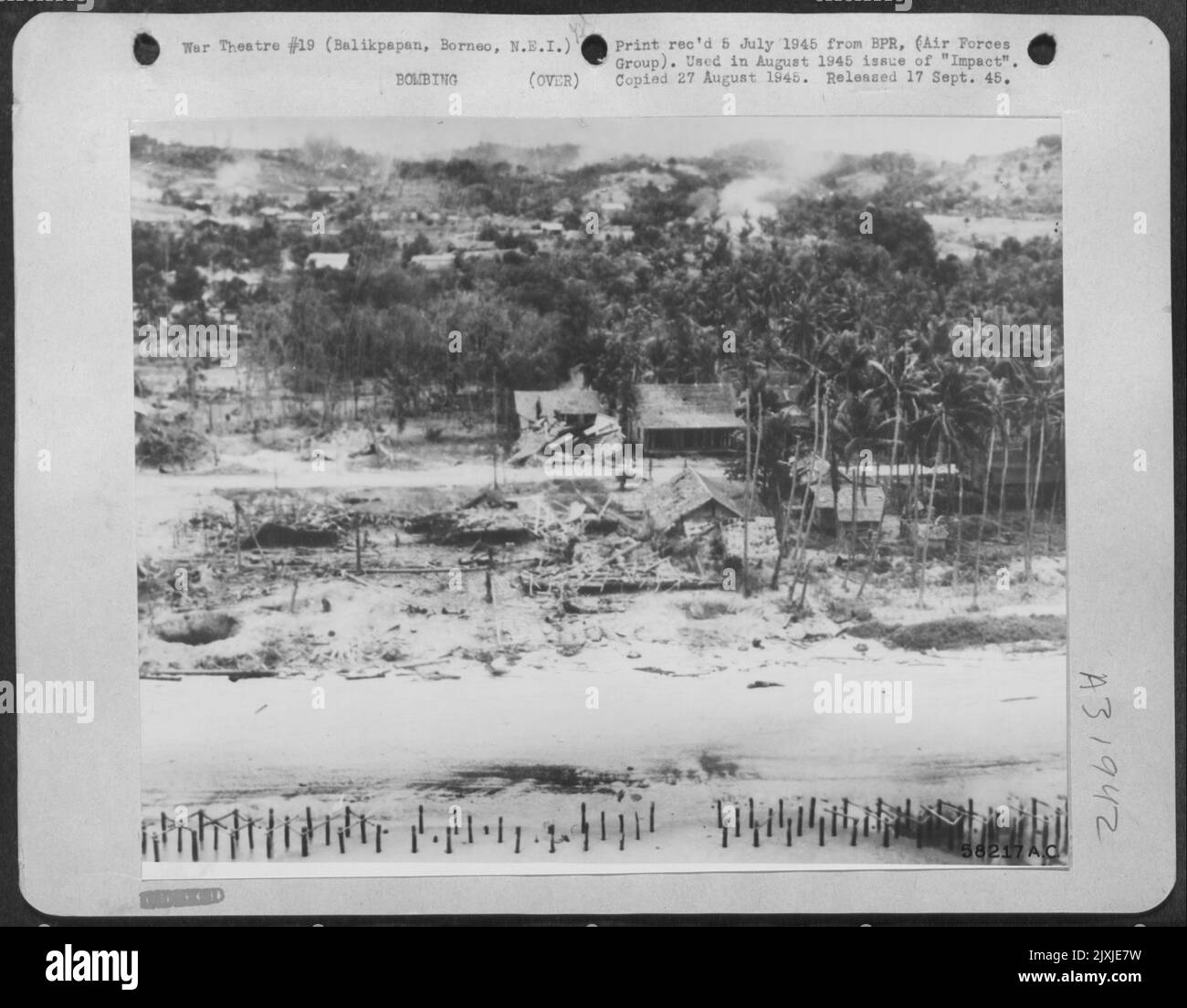 Off-shore log barricade on beach at Balikpapan, Borneo Stock Photo - Alamy