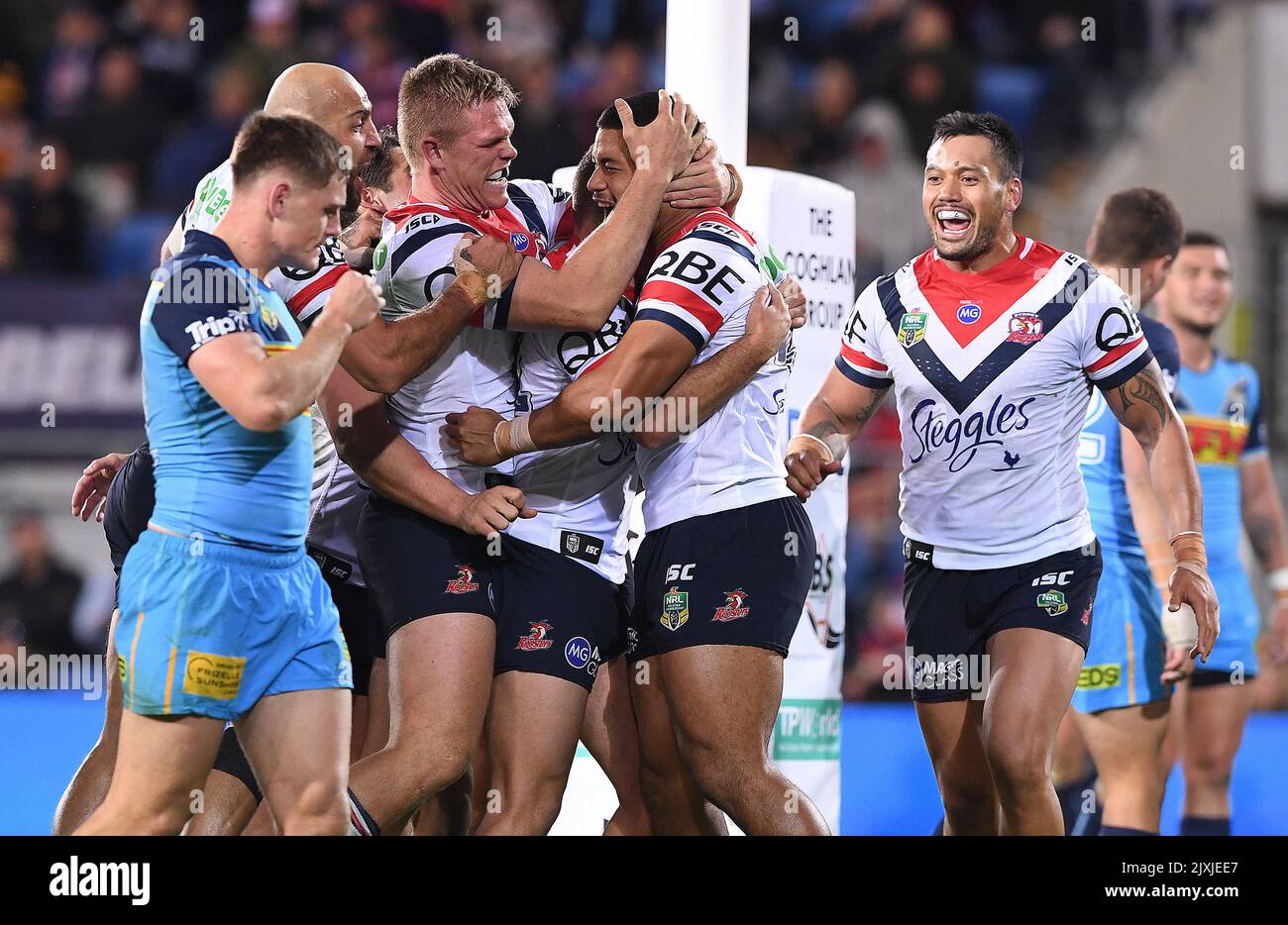 Poasa Faamausili of the Roosters (centre) reacts after scoring a try ...