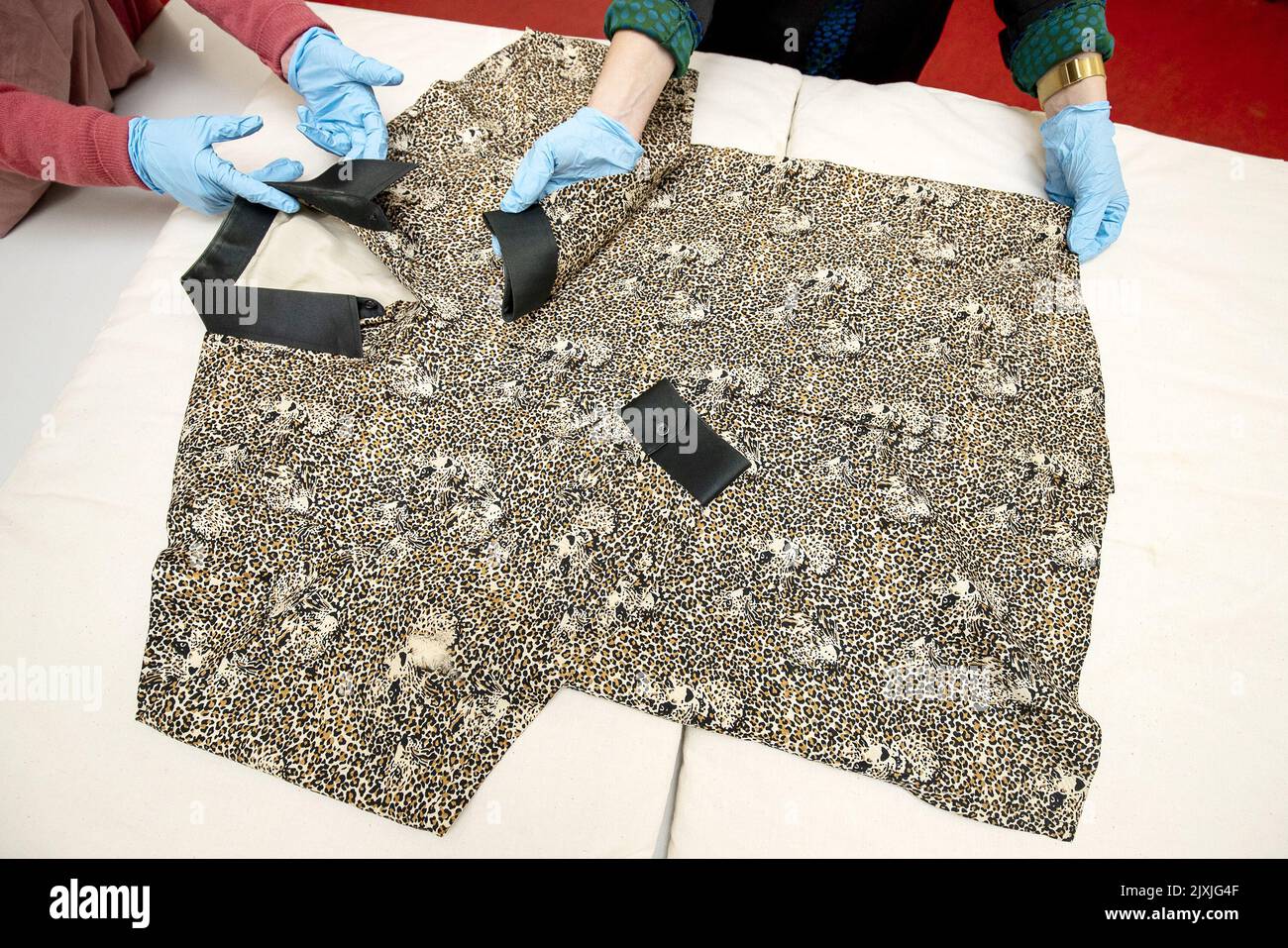 Handlers unveil a shirt worn by Nelson Mandela, which has been flown ...