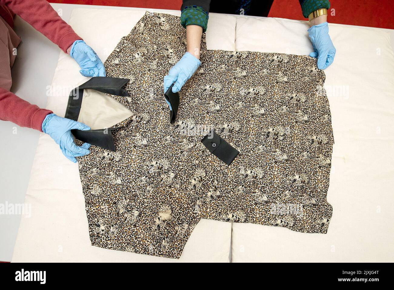 Handlers unveil a shirt worn by Nelson Mandela, which has been flown ...