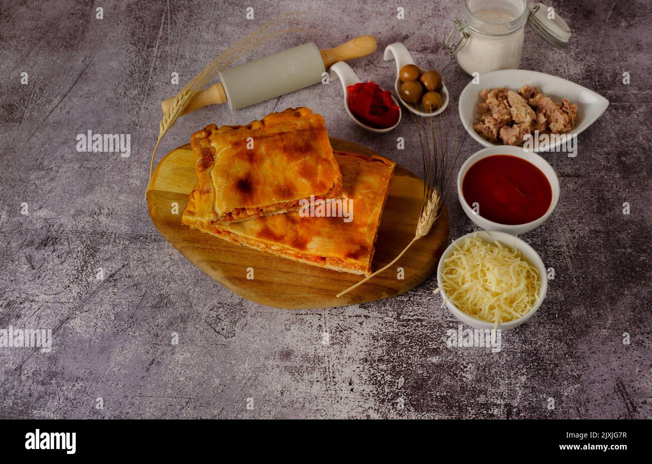 tuna empanada with all the ingredients separated in ceramic containers ...