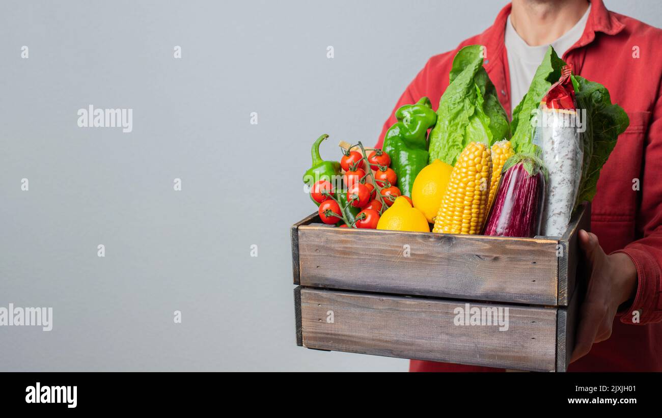 Delivery Concept -Young Caucasian delivery man carrying wooden box of ...