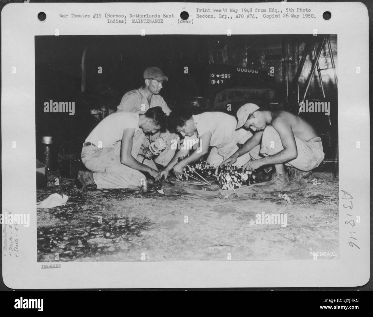 Maintenance men of the 394th Bomb Squadron, 5th Bomb Group, work far ...