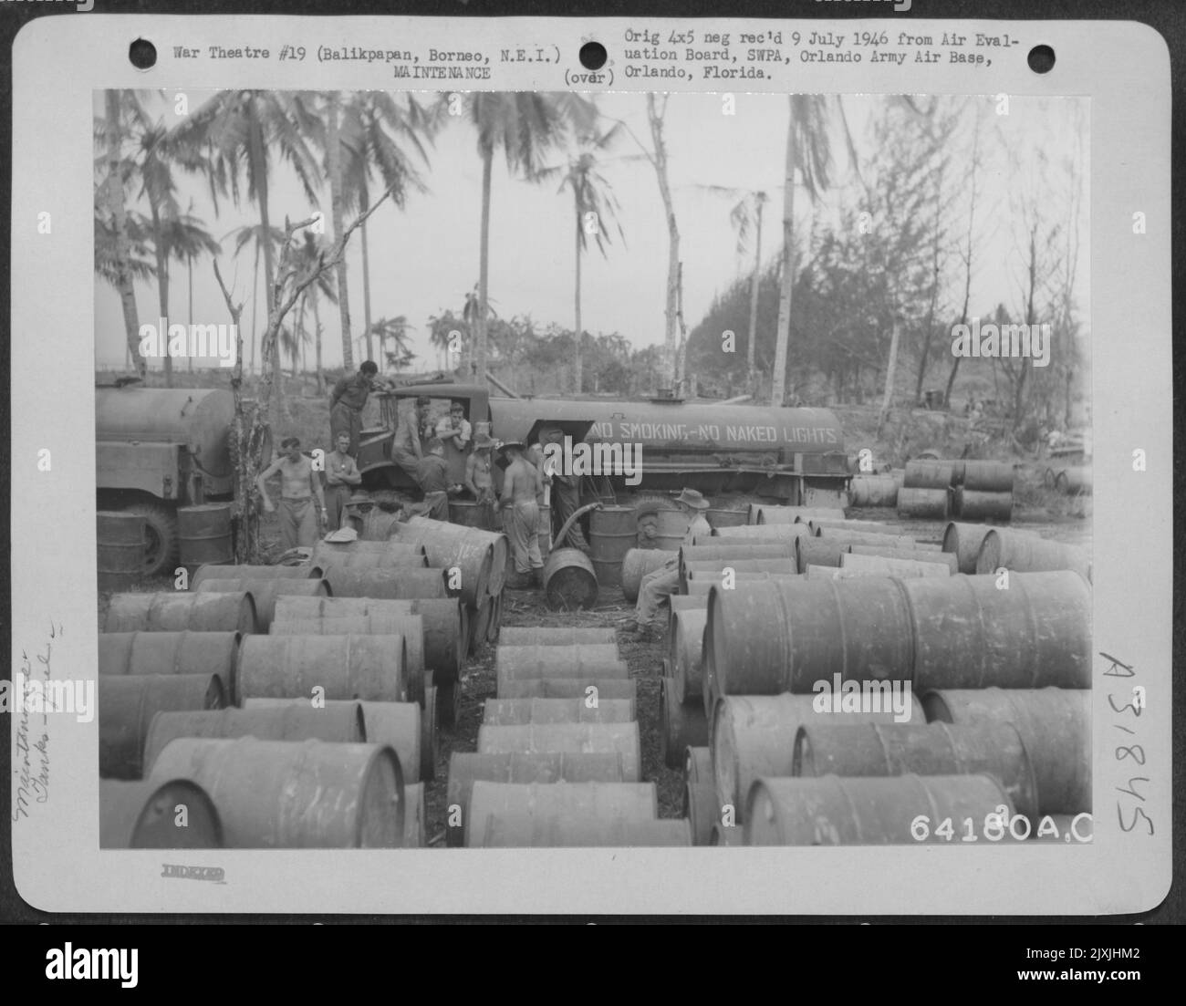 Filling up a gas truck with aviation gasoline at the Sepingang Airstrip ...