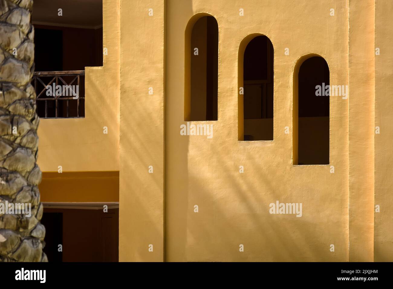 Three arched windows on wall of hotel. Architecture of buildings is in ...