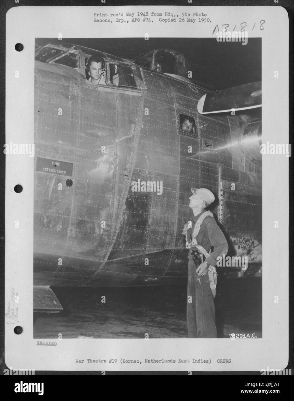 A pilot of the 394th Bomb Squadron, 5th Bomb Group, checks with the ...