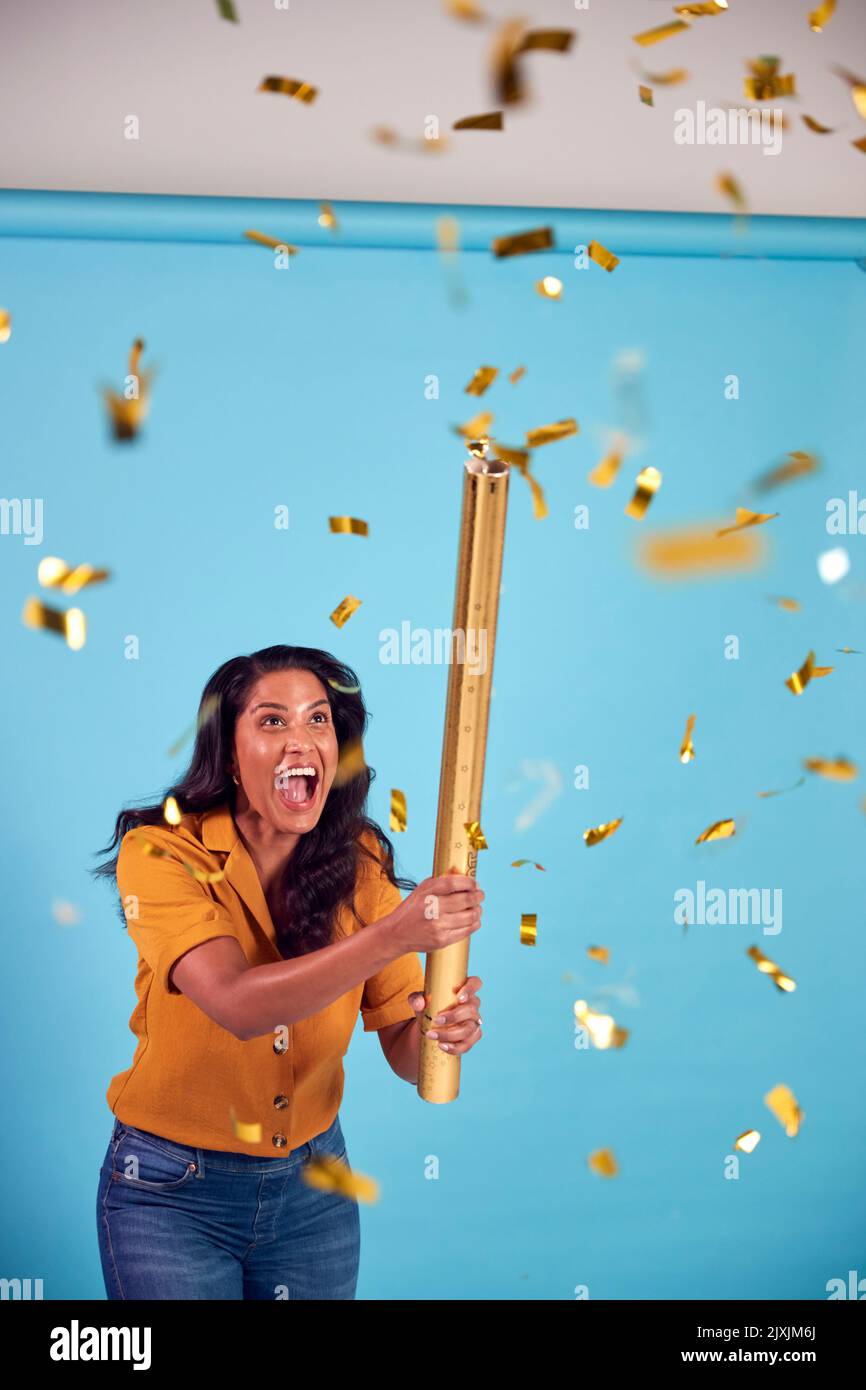 Excited Mature Woman Celebrates Winning Firing Gold Confetti Canon In ...