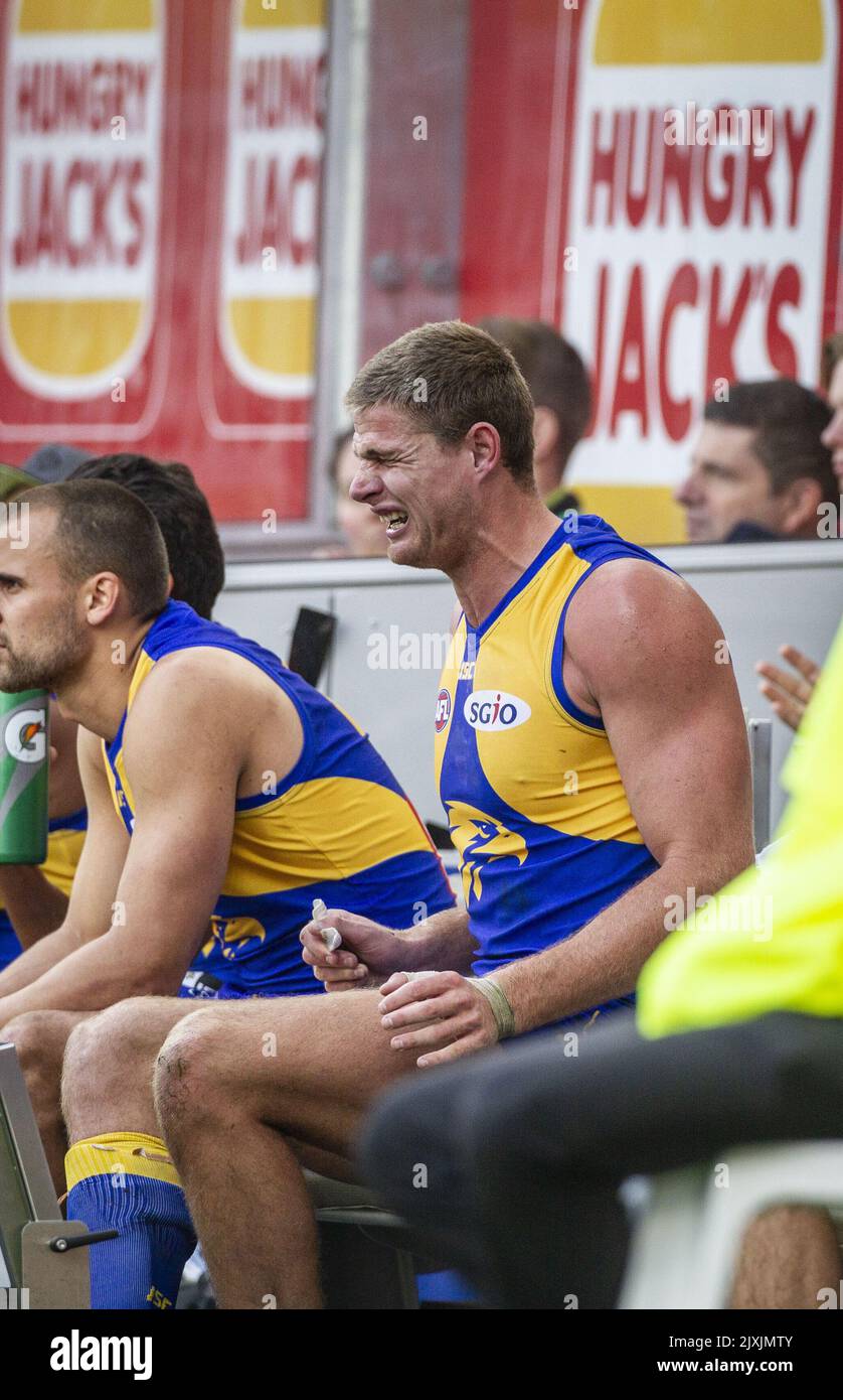 Nathan Vardy of the Eagles (centre) sits on the bench after sustaining ...