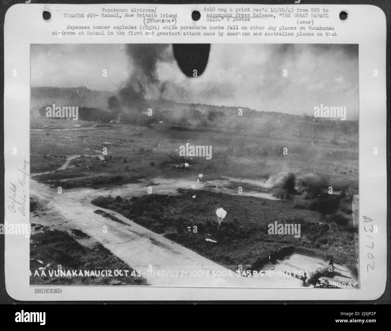 Japaneseanese bomber explodes (right) while parachute bombs fall on ...