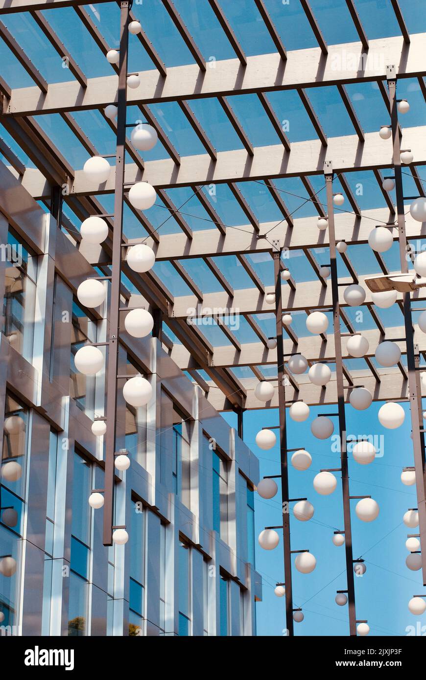 Round light bulbs hanging down from a modern buildings rooftop Stock ...
