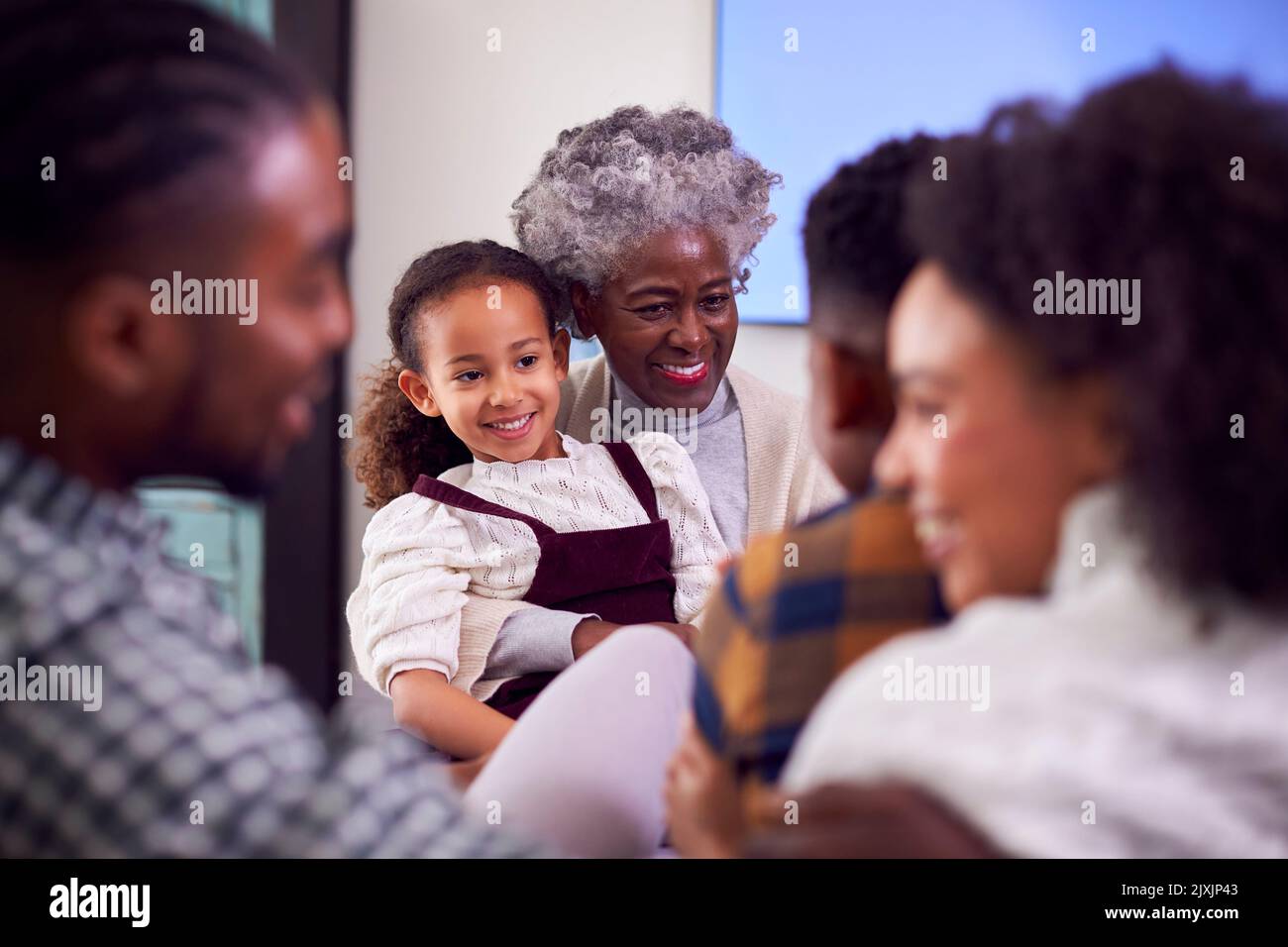 Family relaxing in lounge room hi-res stock photography and images - Alamy