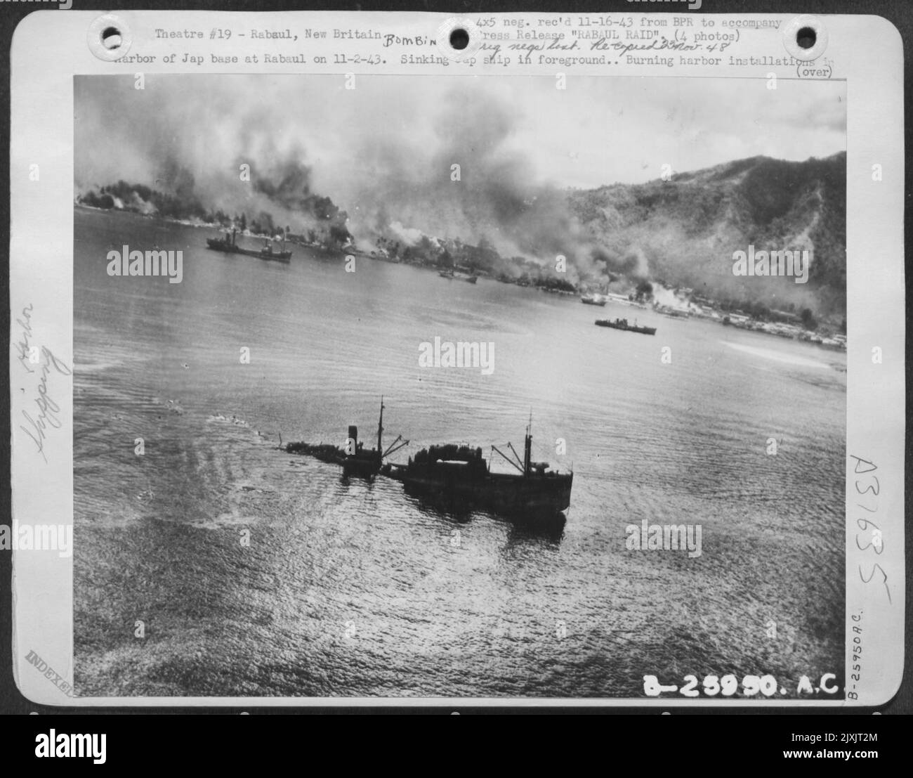 Harbor of Japanese base at Rabaul on 11-2-43. Sinking Japanese ship in ...