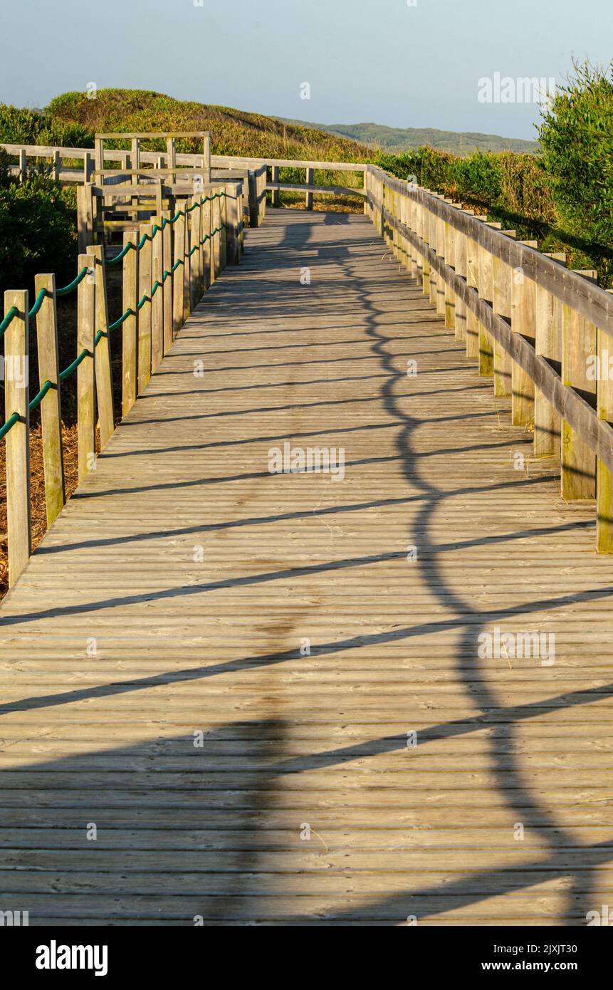 Wooden walkway on a beach at sunrise Stock Photo - Alamy