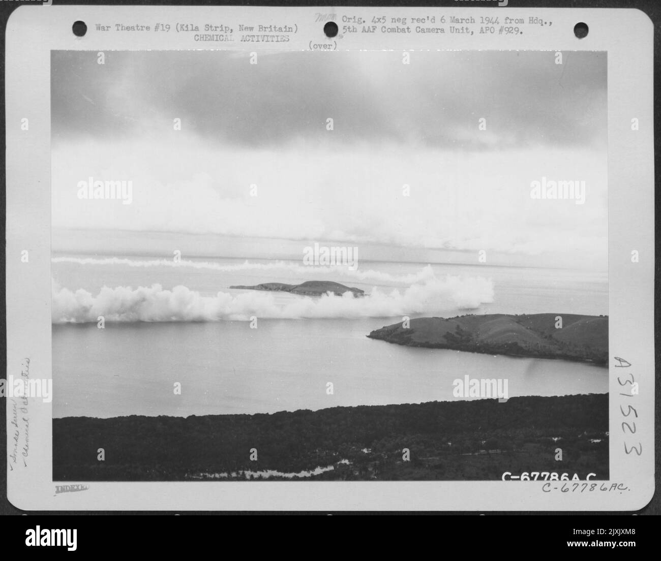 A smoke screen is laid by a North American B-25 during tests off Kila ...