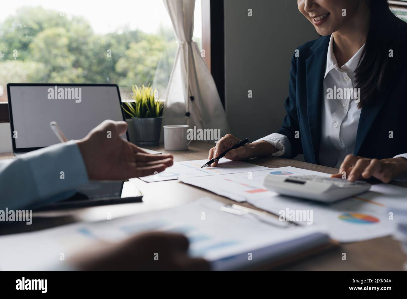 Business team using calculator to calculate the company's financial ...