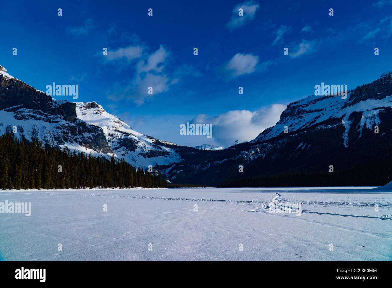A scenic view of frozen mountain lake in winter with blue sky background Stock Photo - Alamy