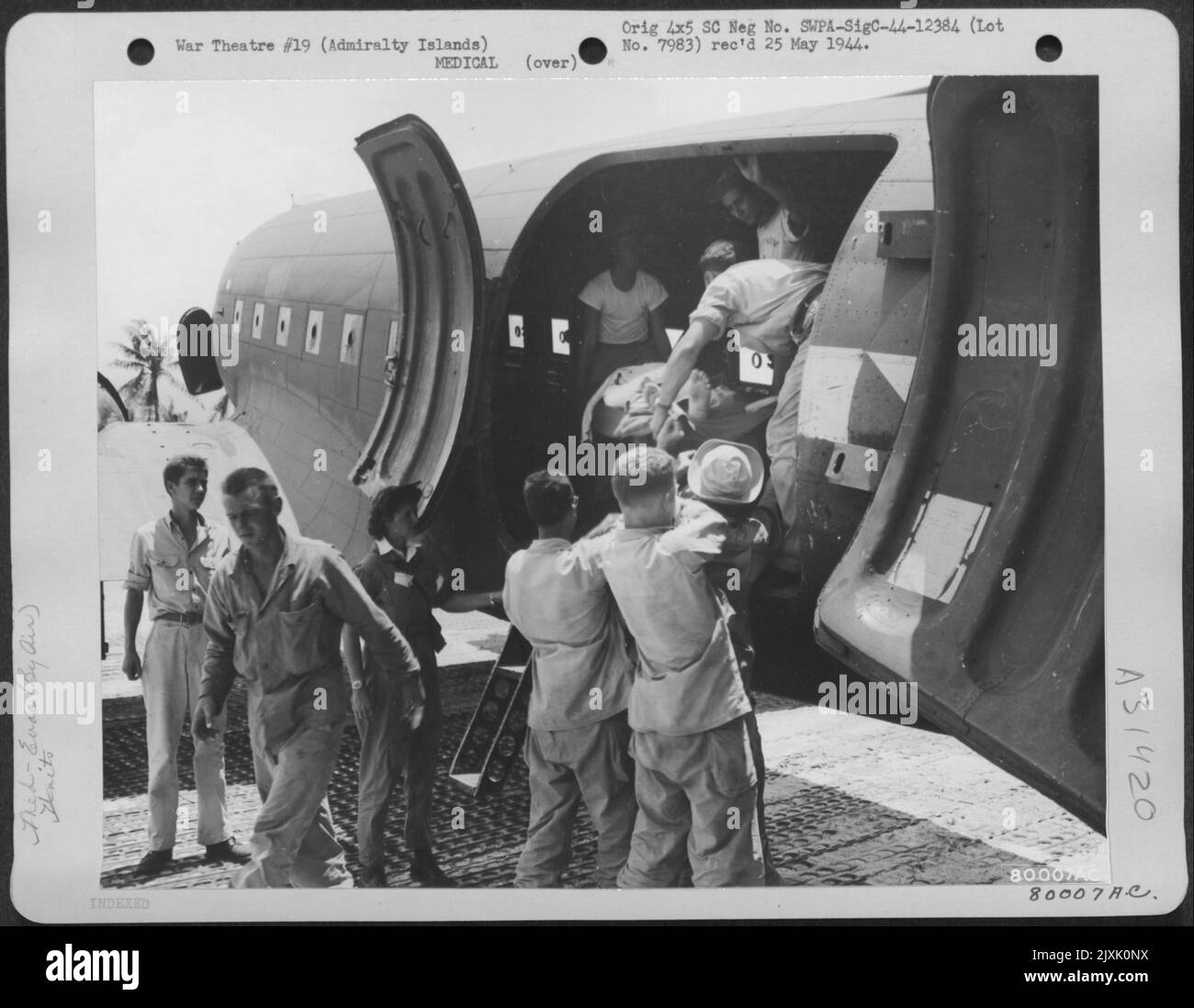 Patients at the 58th Evacuation Hospital are loaded aboard a Douglas C ...