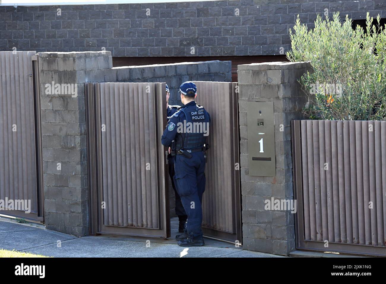 Police are seen outside the house of Kings Cross nightclub owner John ...