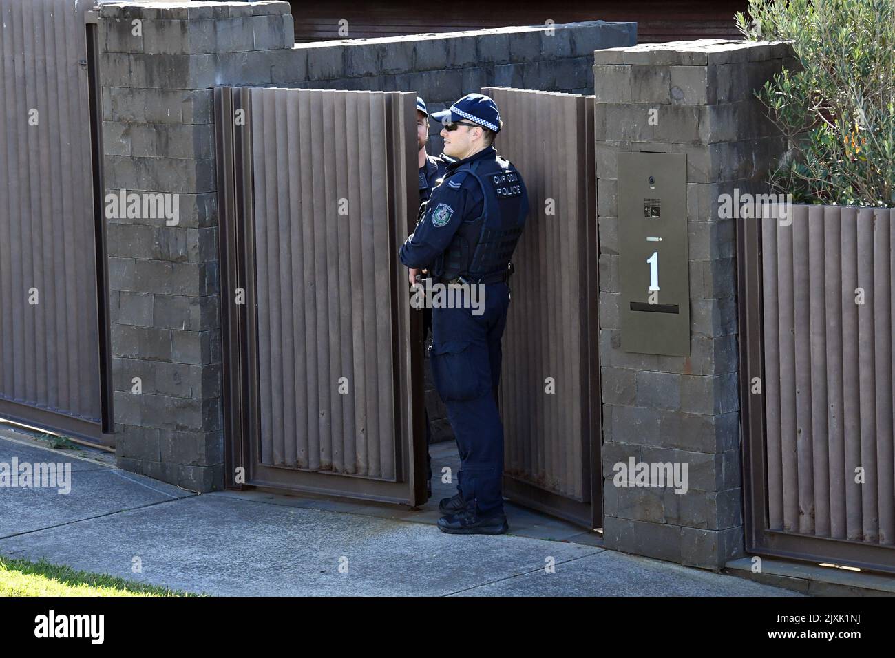 Police are seen outside the house of Kings Cross nightclub owner John ...
