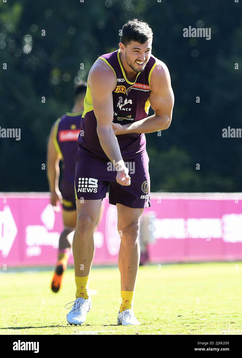 Corey Oates grimaces as he holds his arm during the Brisbane Broncos ...