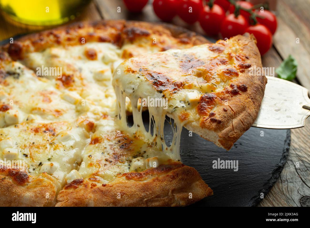 A slice of hot Italian pizza with stretching cheese. Pizza four cheeses ...