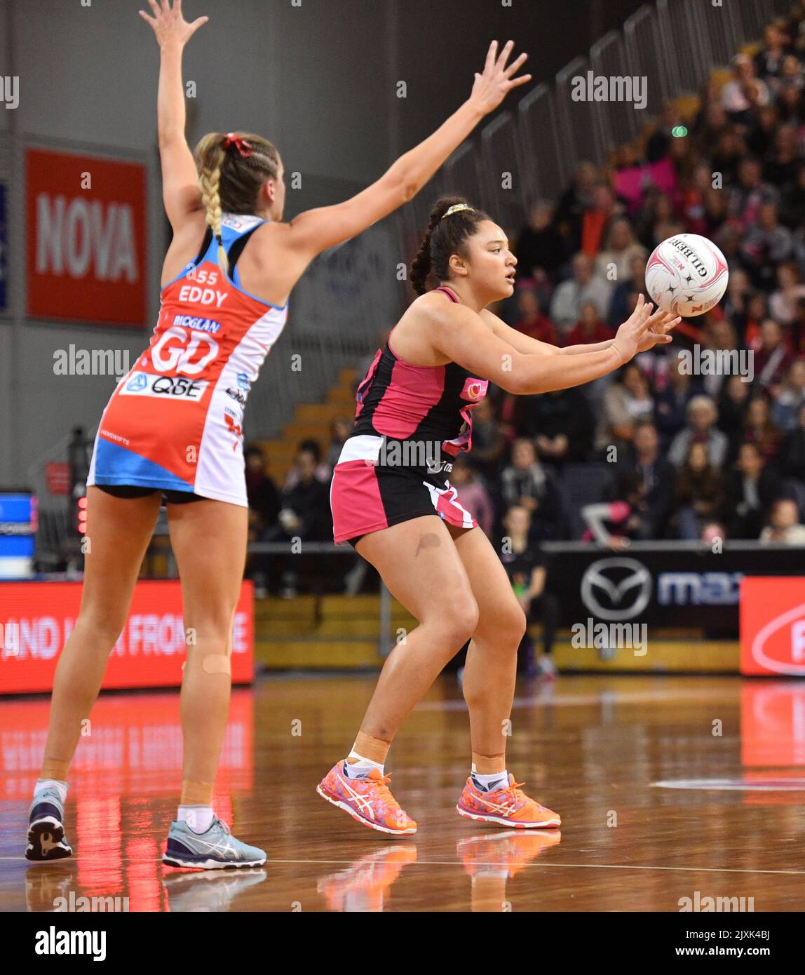 Abigail Latu-Meafou of the Thunderbirds (right) grabs the ball as Kate ...