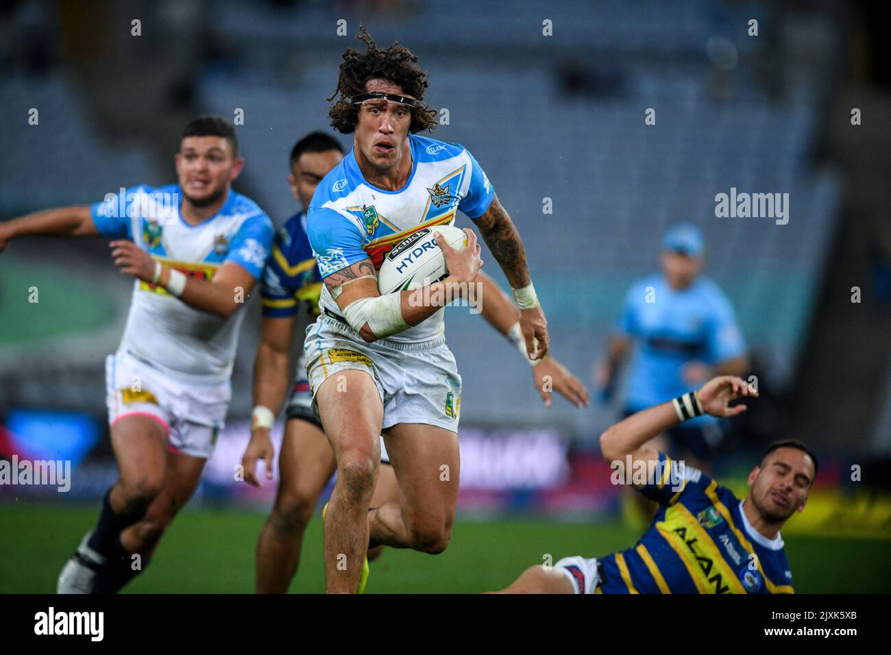 Kevin Proctor (left) of the Titans runs with the ball against the Eels ...