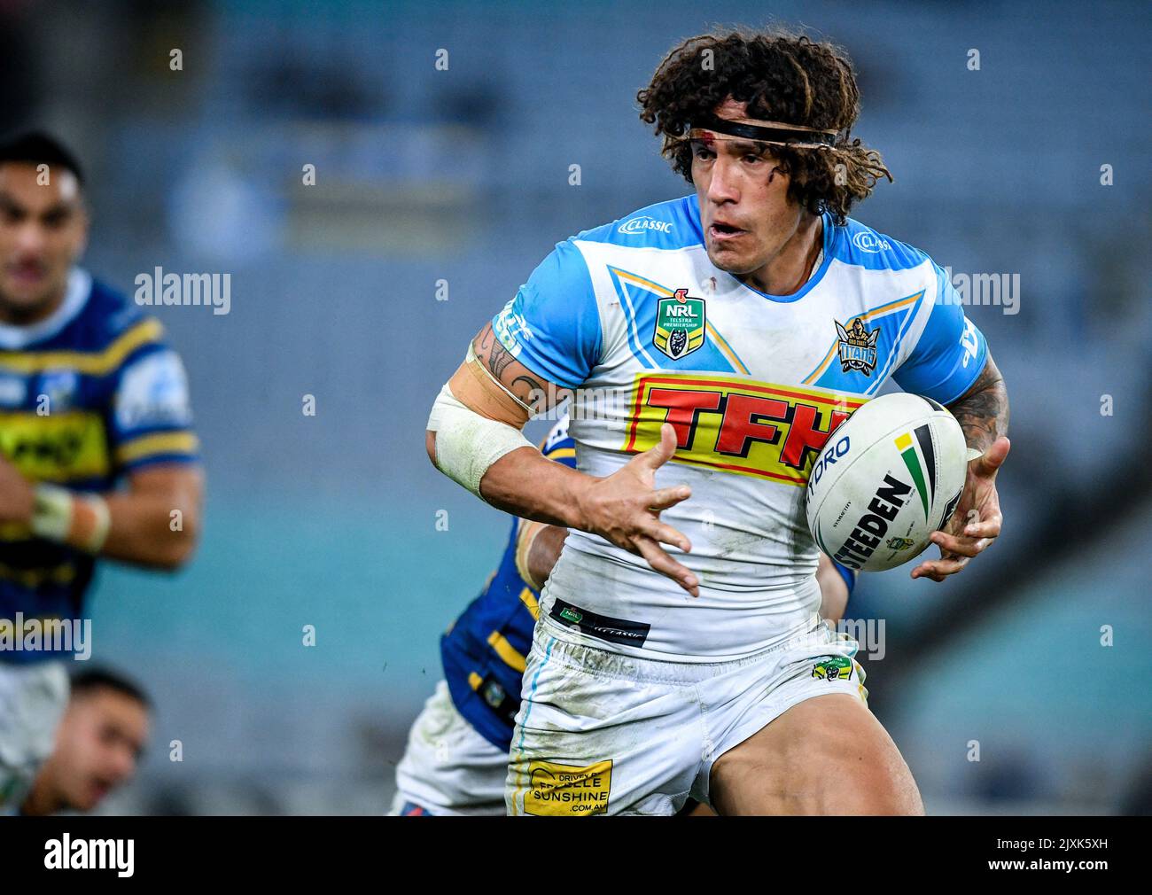 Kevin Proctor (left) of the Titans runs with the ball against the Eels ...