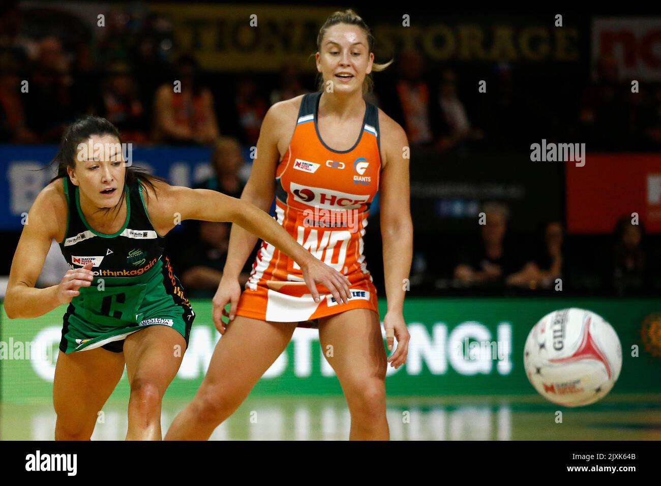 Verity Charles of the Fever (left) chases the loose ball during the ...