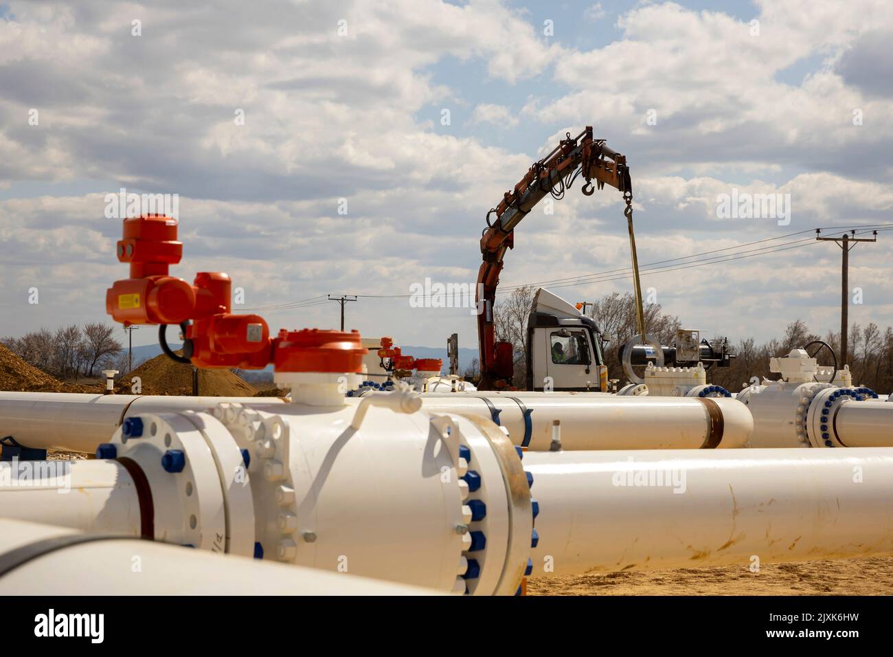 Worker works on a construction site of an interconnected natural gas ... Worker works on a construction site of an interconnected natural gas ...
