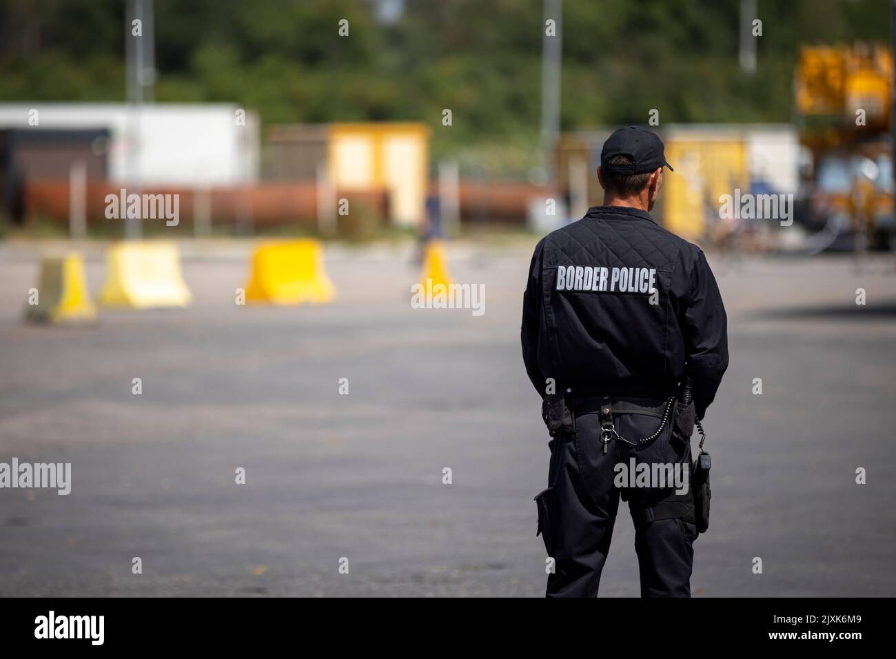 Border police officer is seen from the back guarding the a border Stock ...