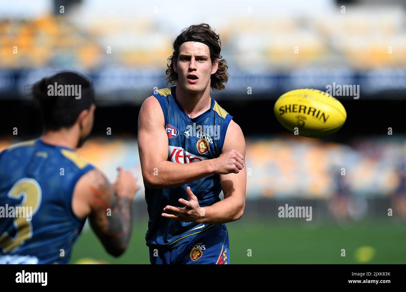 Brisbane Lions player Jarred Berry handballs during a team training ...