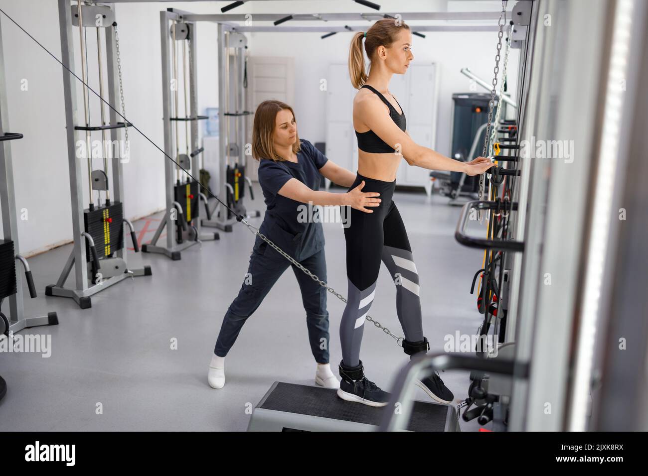 Woman doing exercise on decompression simulators with trainer ...