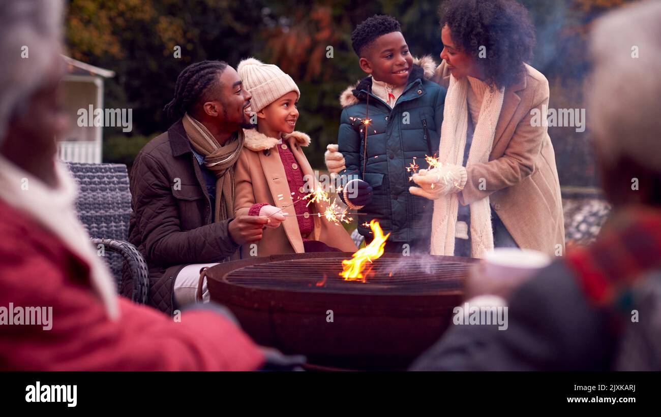 Multi-Generation Family Having Fun With Firework Sparklers In Autumn ...