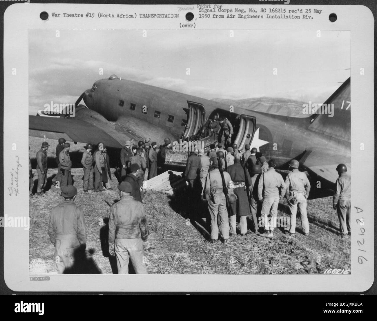 A bulldozer being put aboard a Douglas C-47 transport plane at an ...