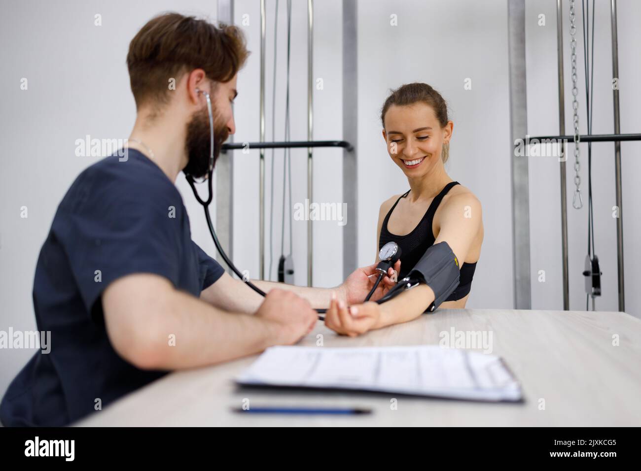Happy fitness woman on physical examination at sports doctor ...