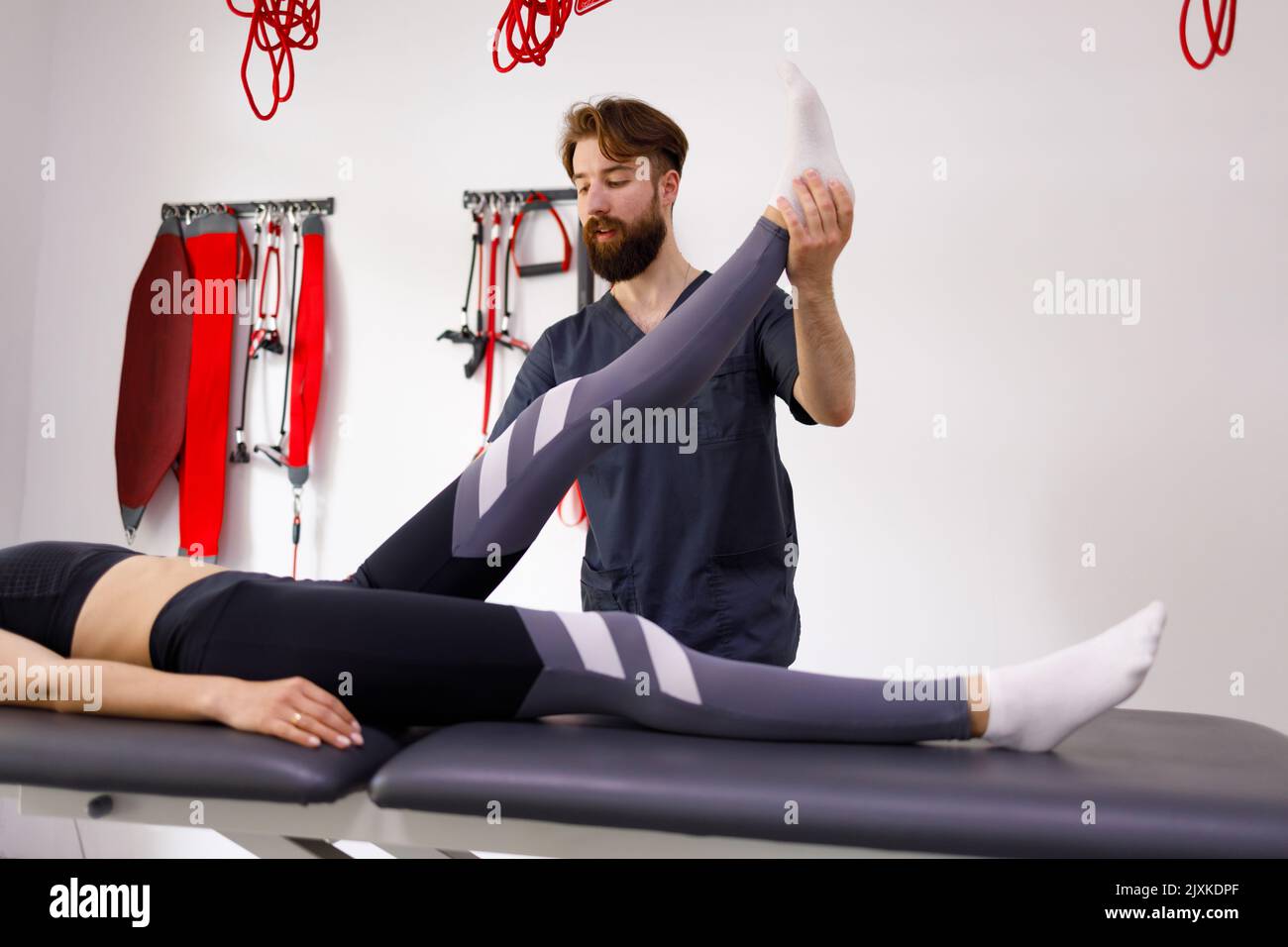 Doctor working with female patient in clinic. Rehabilitation ...