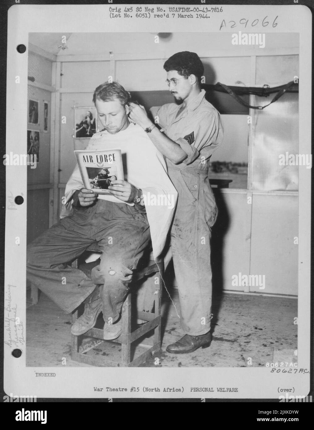 Sgt. Kim Edgmand of Enterprise, Ore., cuts the hair of Sgt. Cecil Hale ...