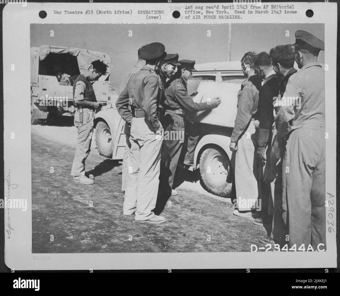 An intelligence officer interviews a group of RAF fighter pilots who ...