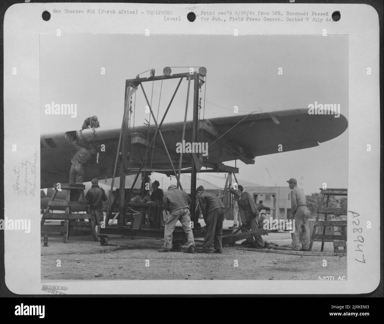 A TREMENDOUS TIME AND LABOR SAVER is the huge wing-hoist pictured here ...