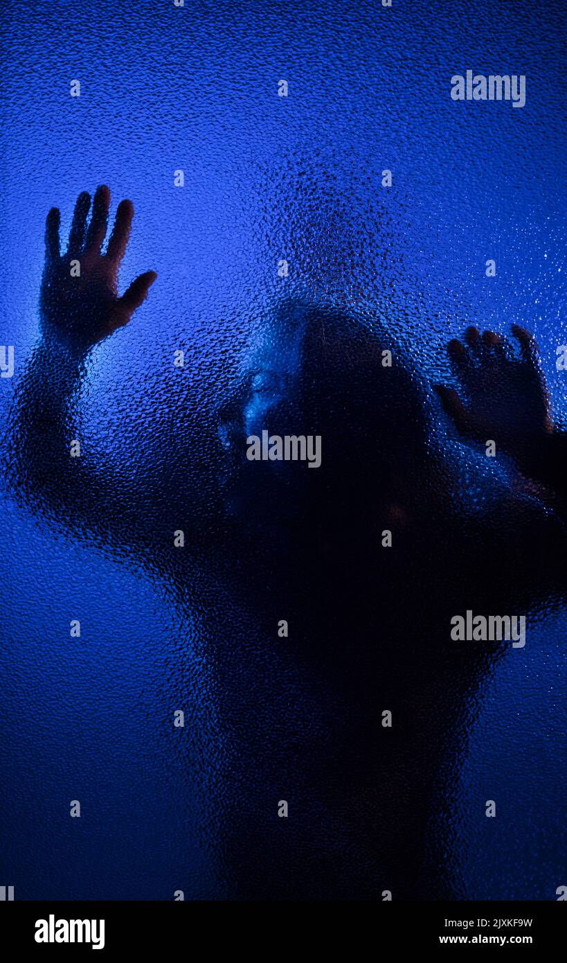 Shadow of woman screaming behind the glass, domestic violence concept ...