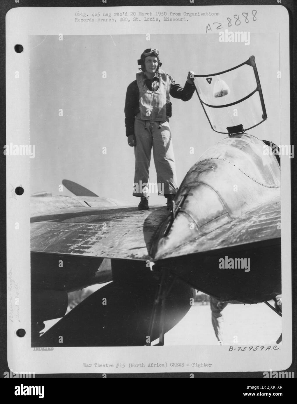 A pilot of the 90th Photographic Reconnaissance Wing, poses on the wing ...