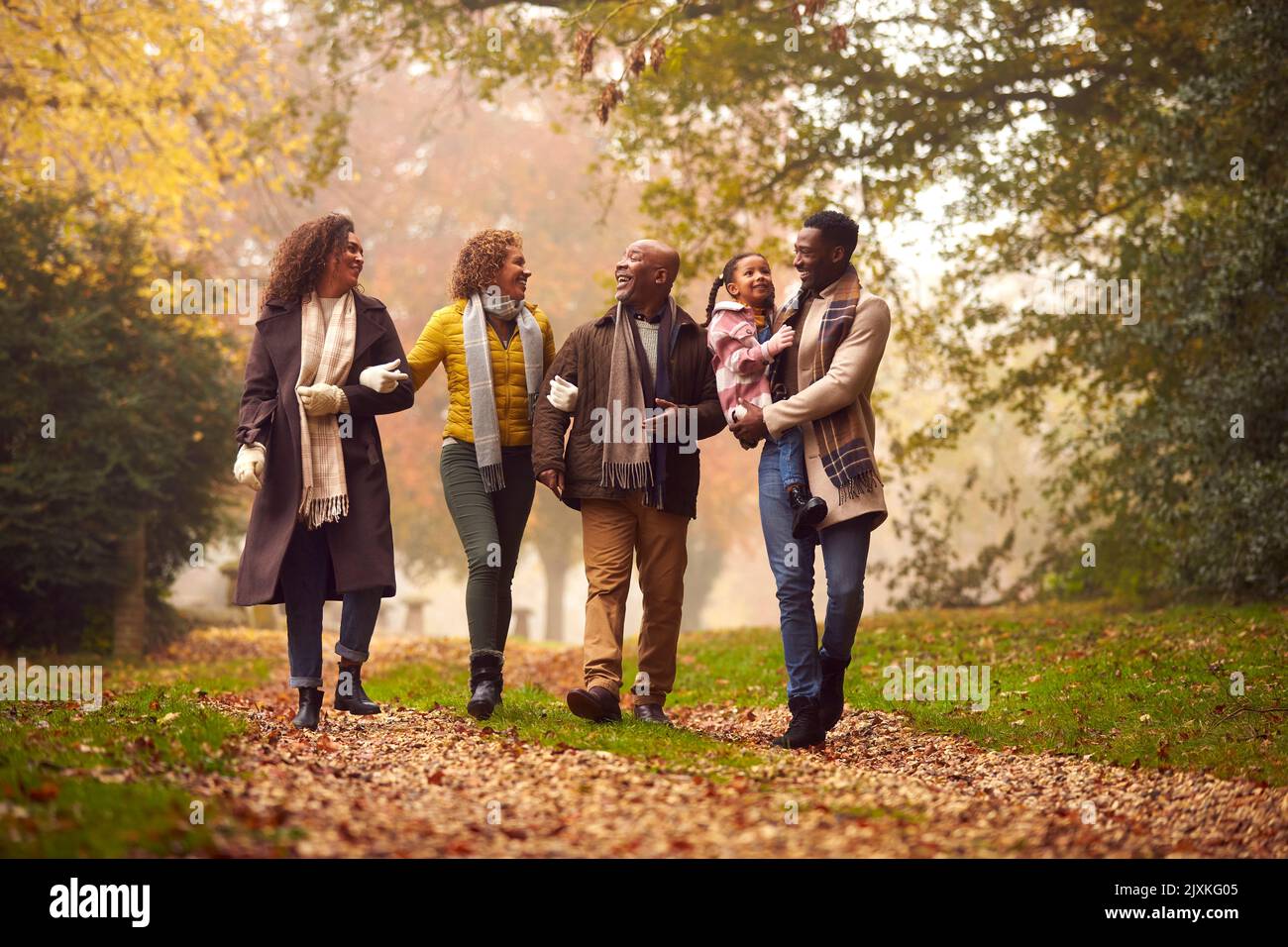 Smiling Multi-Generation Family Having Fun With Daughter Walking ...