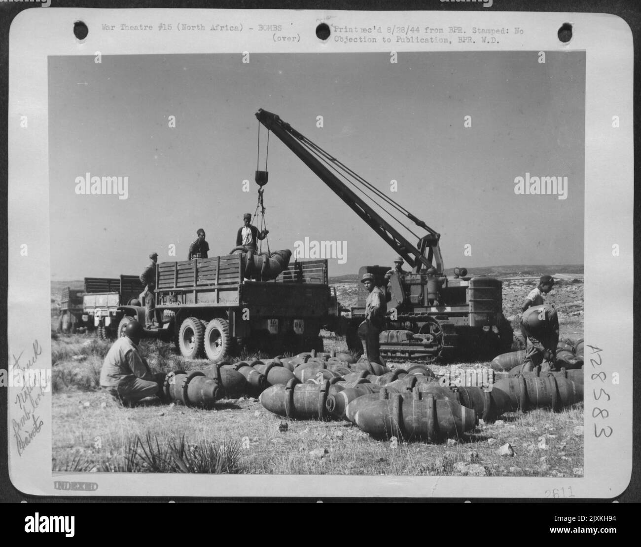 NATIVE WORKMEN load bombs aboard an Ordnance truck at an Air Service ...