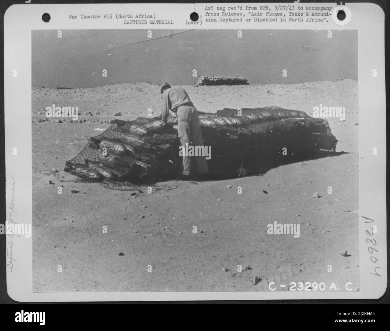 North Africa-Lt. Graham inspects a cache of German 100 kilgm. Bombs at ...